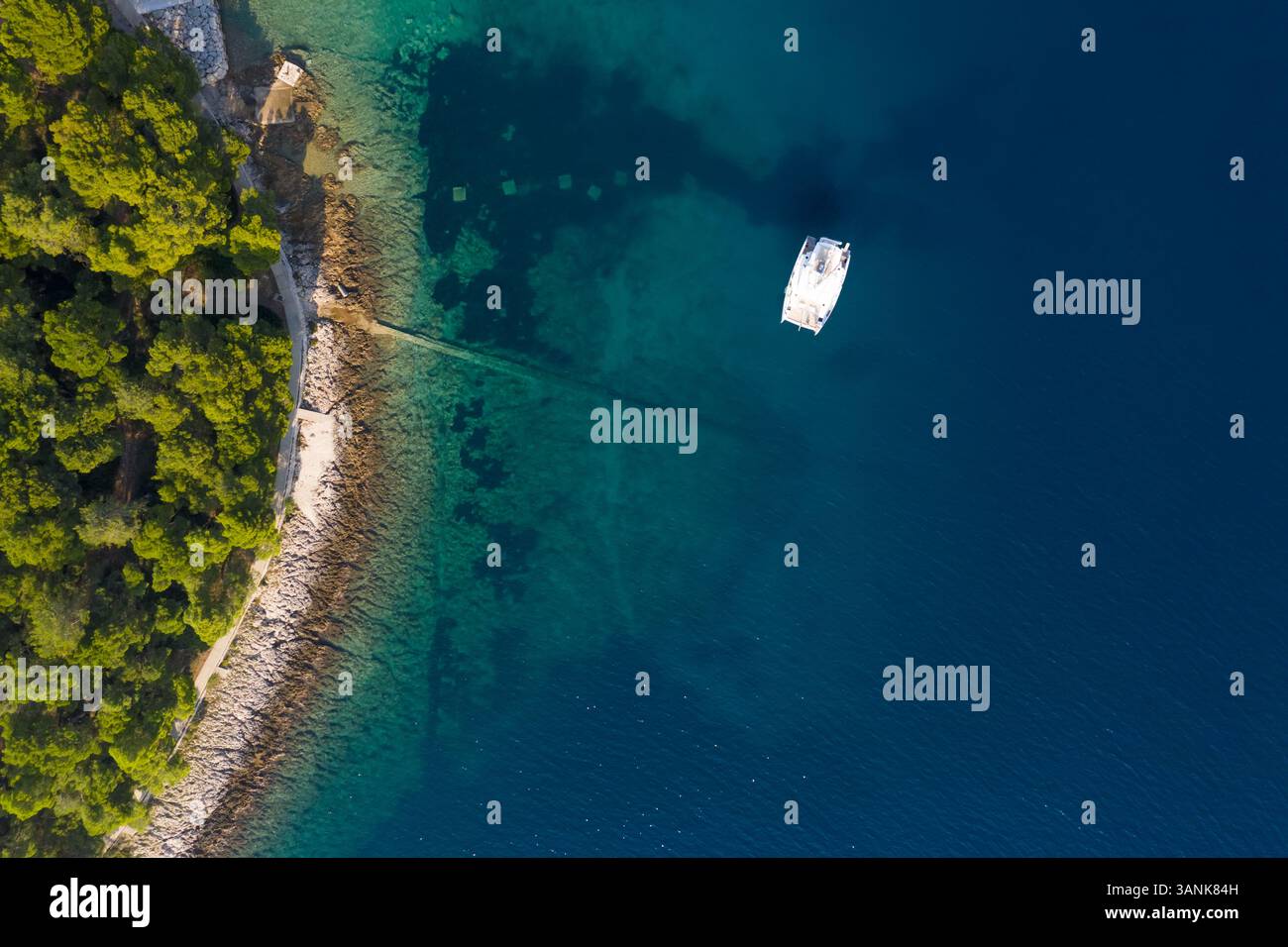 Aerial view of single speed boat floating over transparent water ...