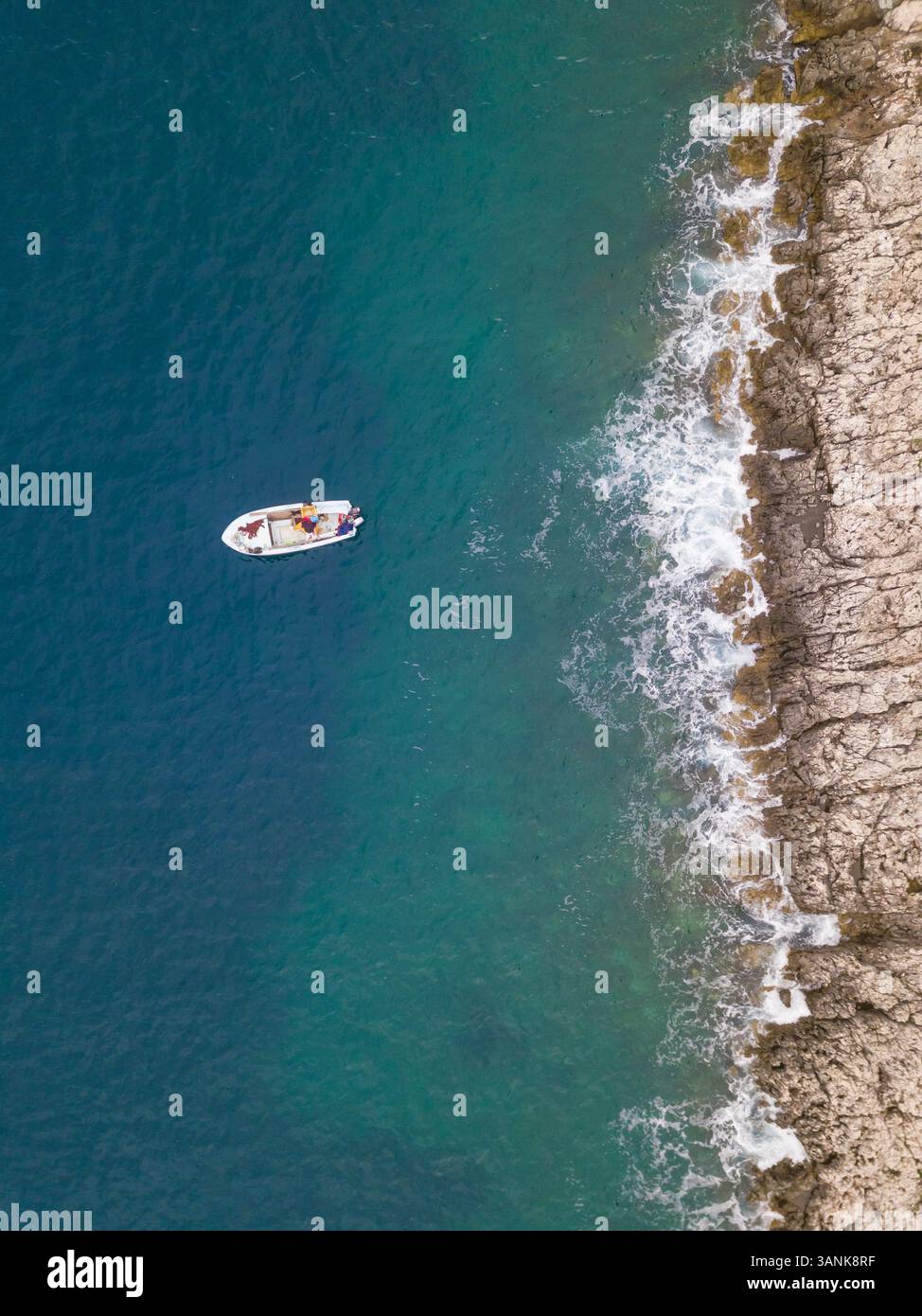 Aerial view of single speed boat floating over transparent water ...