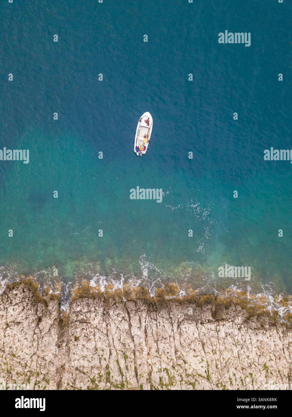 Aerial view of single speed boat floating over transparent water ...