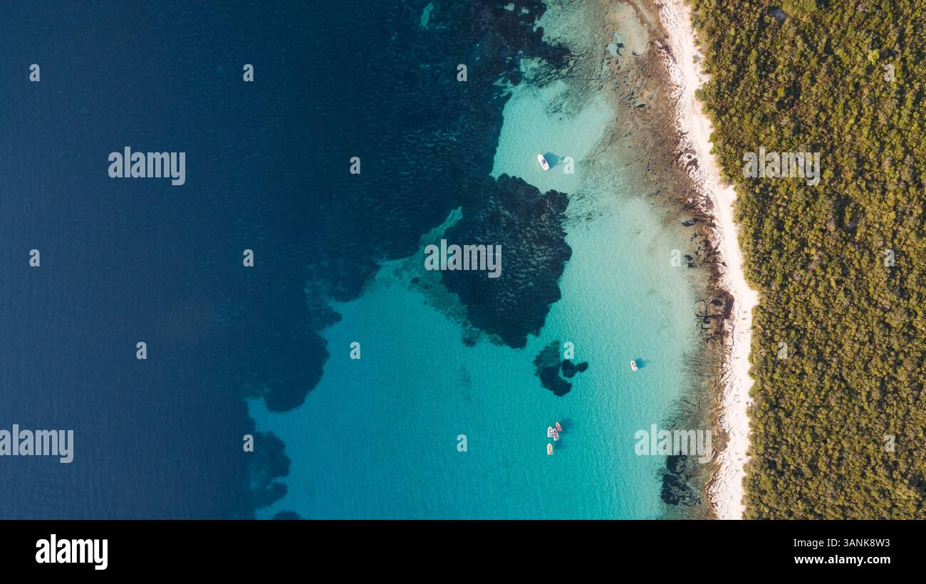 Aerial view of single speed boat floating over transparent water ...