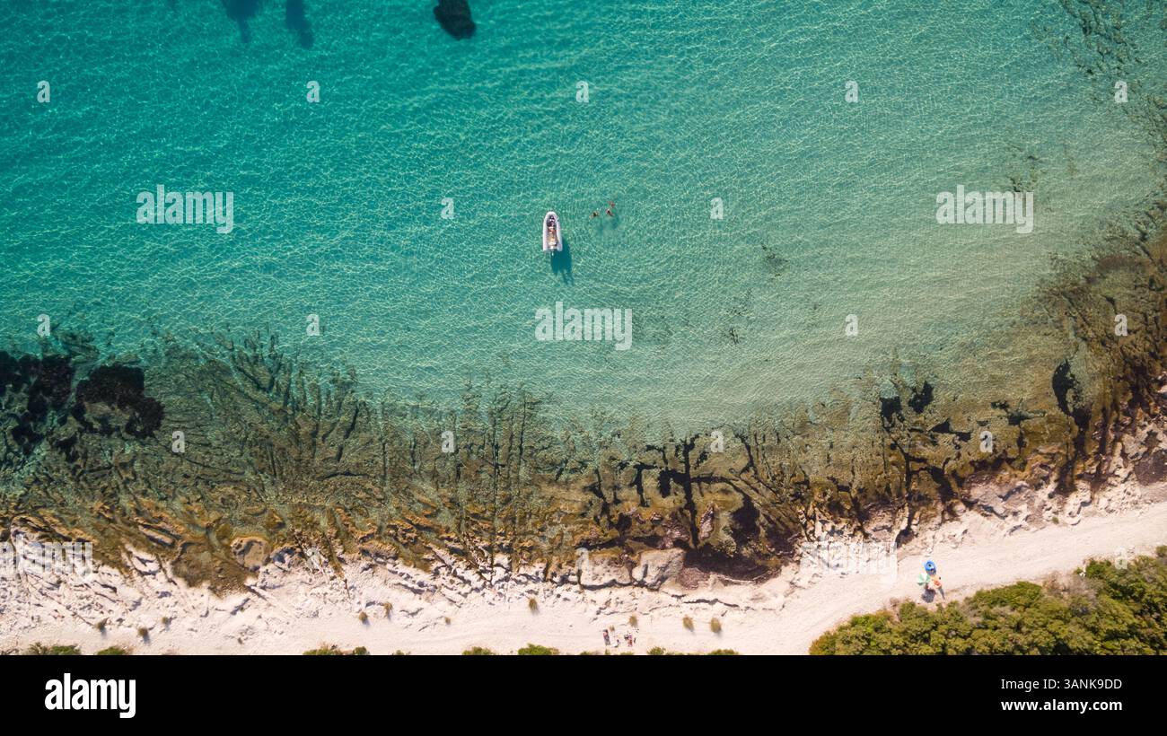 Aerial view of single speed boat floating over transparent water ...