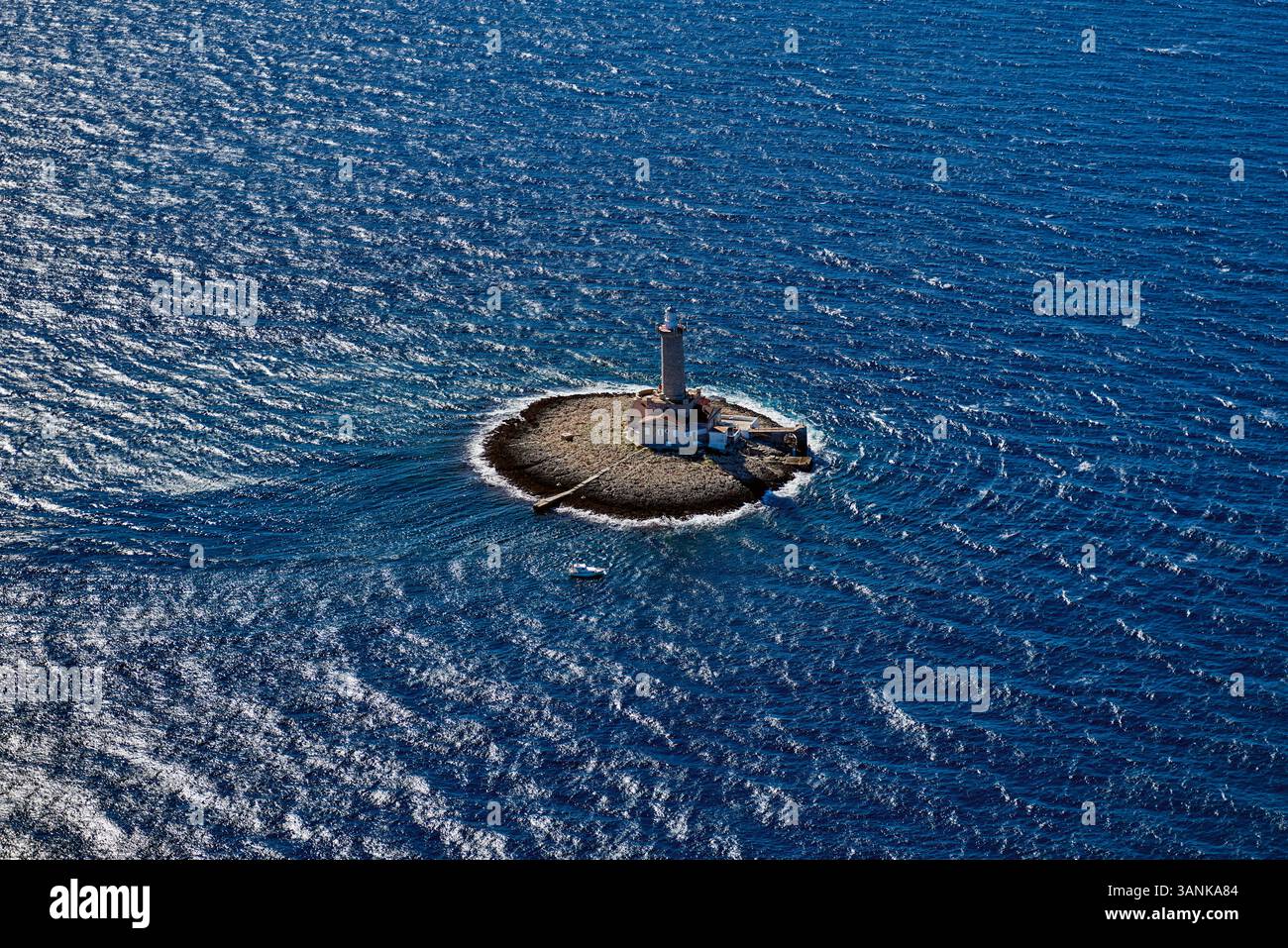Aerial view of tranquil Lighthouse Porer on a remote island, Premantura ...