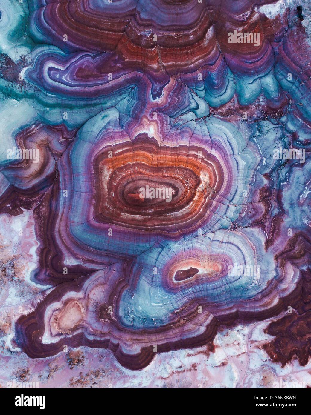 Aerial view of colorful geological formations with layered textures and ...