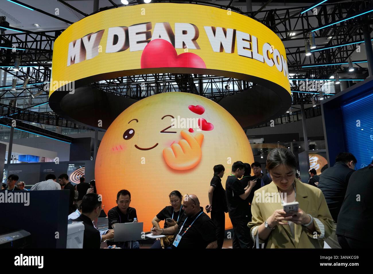 A smiley face greets visitors at the booth for Midea, a Chinese home ...