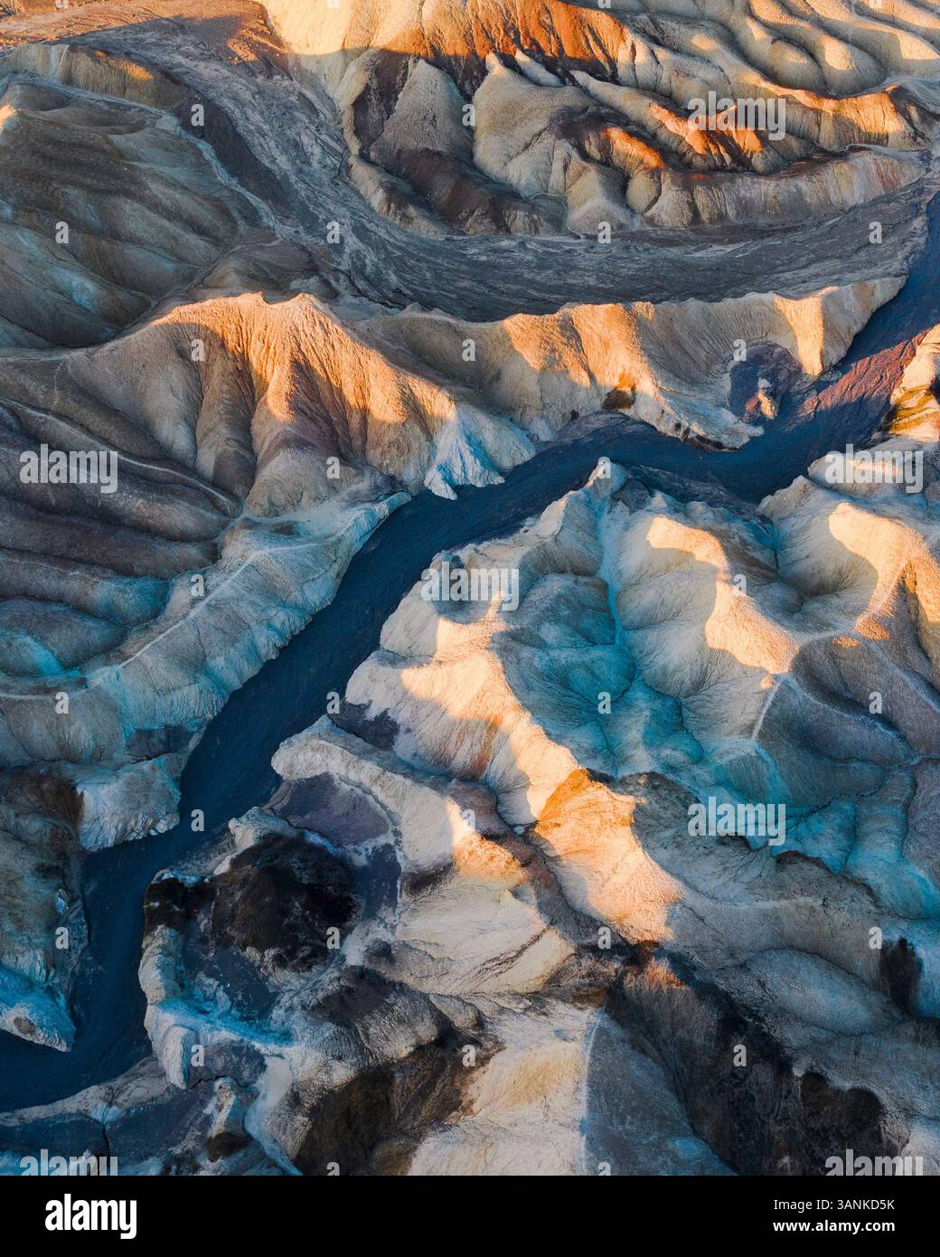 Aerial view of dramatic rock formations and rugged canyon with shadows ...