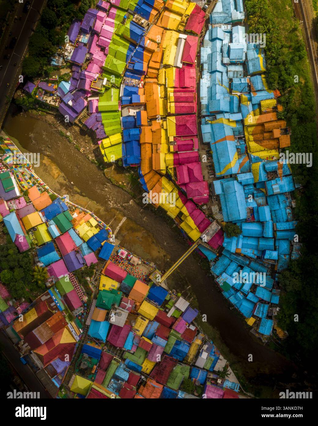 Aerial view of colorful houses and a river with a bridge in a vibrant ...