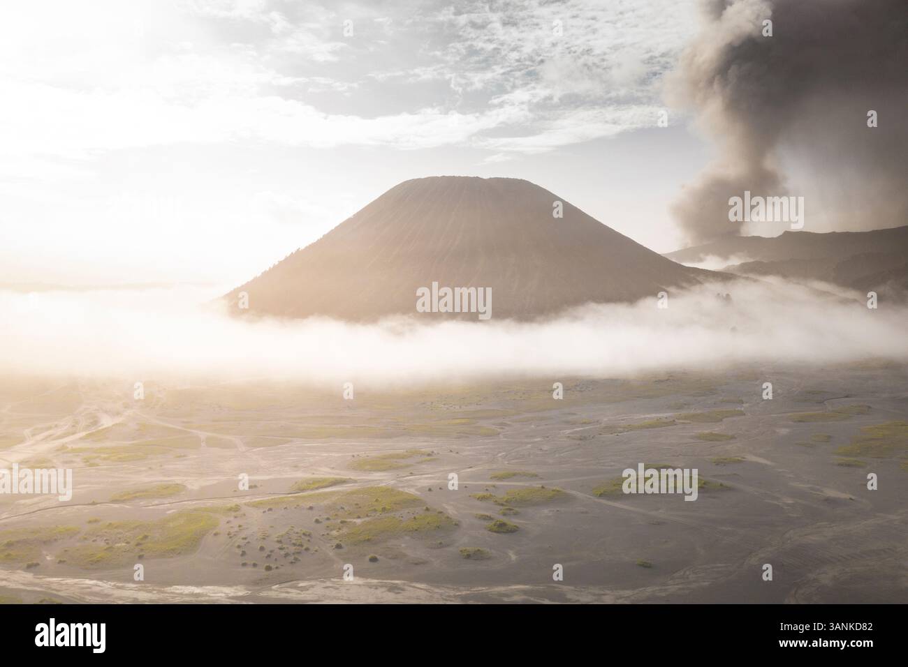 Aerial view of the majestic volcano with smoke and ash rising above the ...