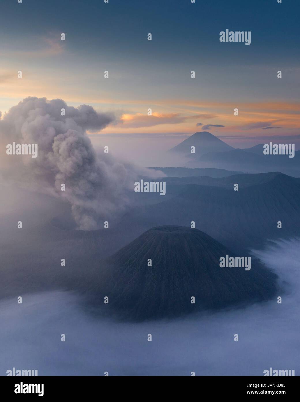 Aerial view of bromo mountain with smoke and clouds at sunrise, Tosari ...
