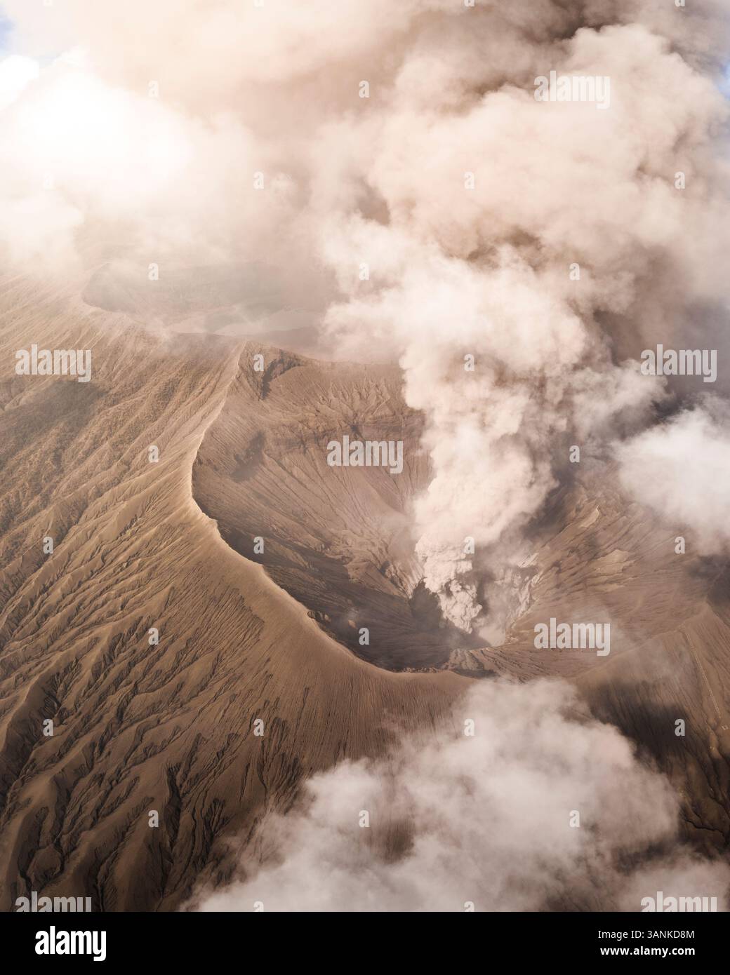 Aerial view of the majestic smoking volcano with a dramatic crater and ...