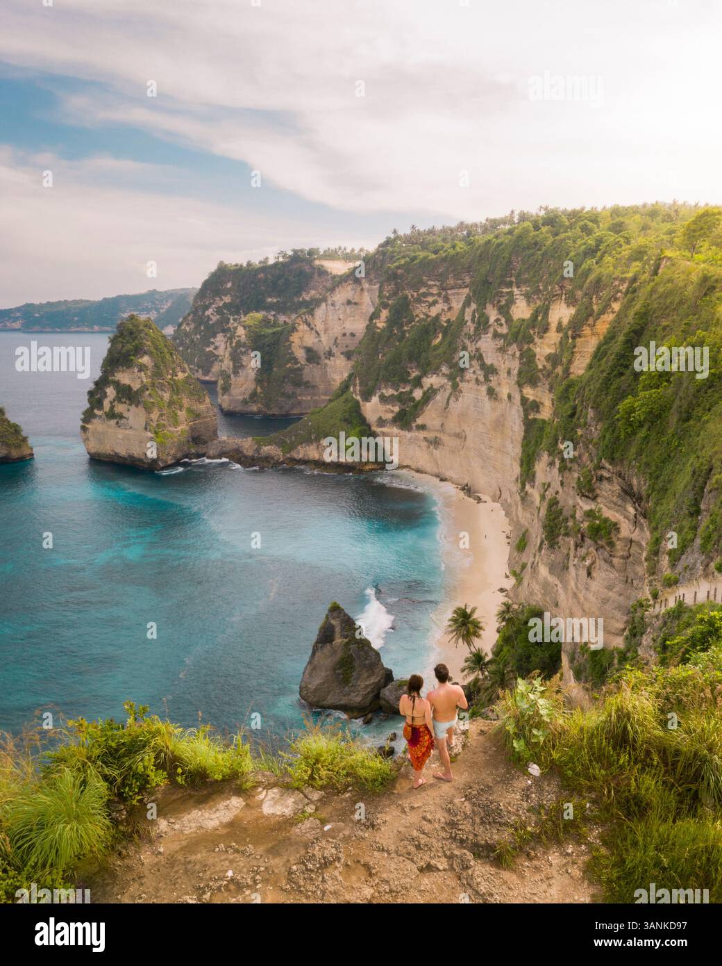 Aerial view of beautiful rugged cliffs and pristine beach by the serene ...