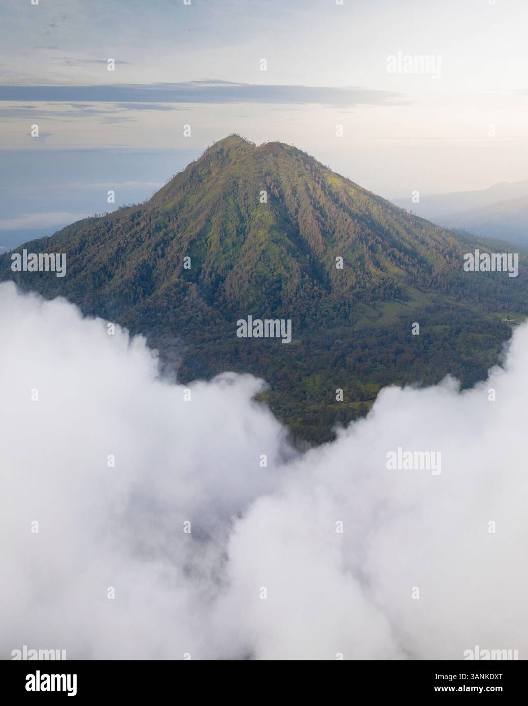 Aerial view of a majestic volcano surrounded by lush greenery and ...