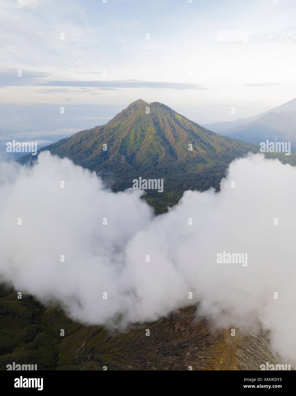 Aerial view of the majestic Licin volcano surrounded by serene clouds ...