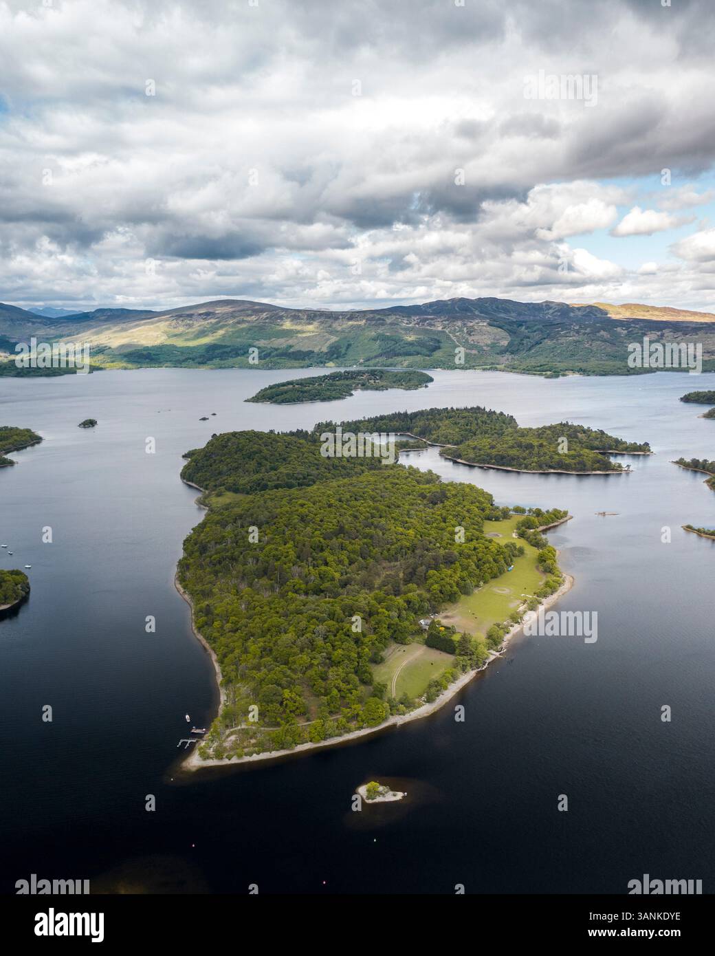 Aerial view of serene and picturesque Loch Lomond with lush greenery ...