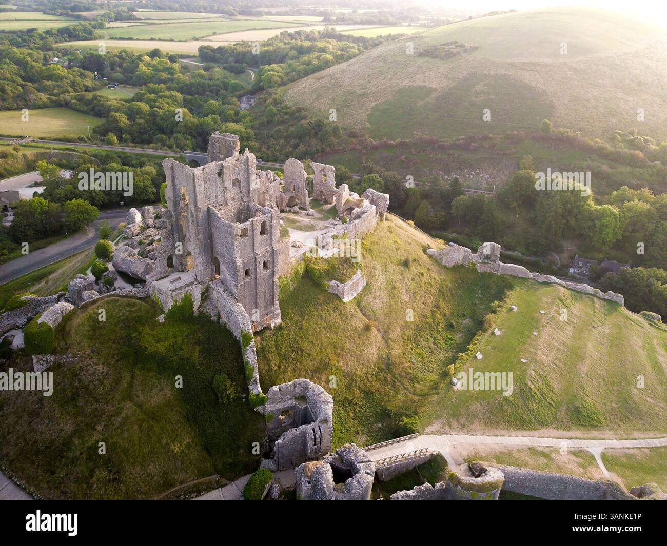 Aerial view of the historic ruins of Corfe Castle on a hill surrounded ...