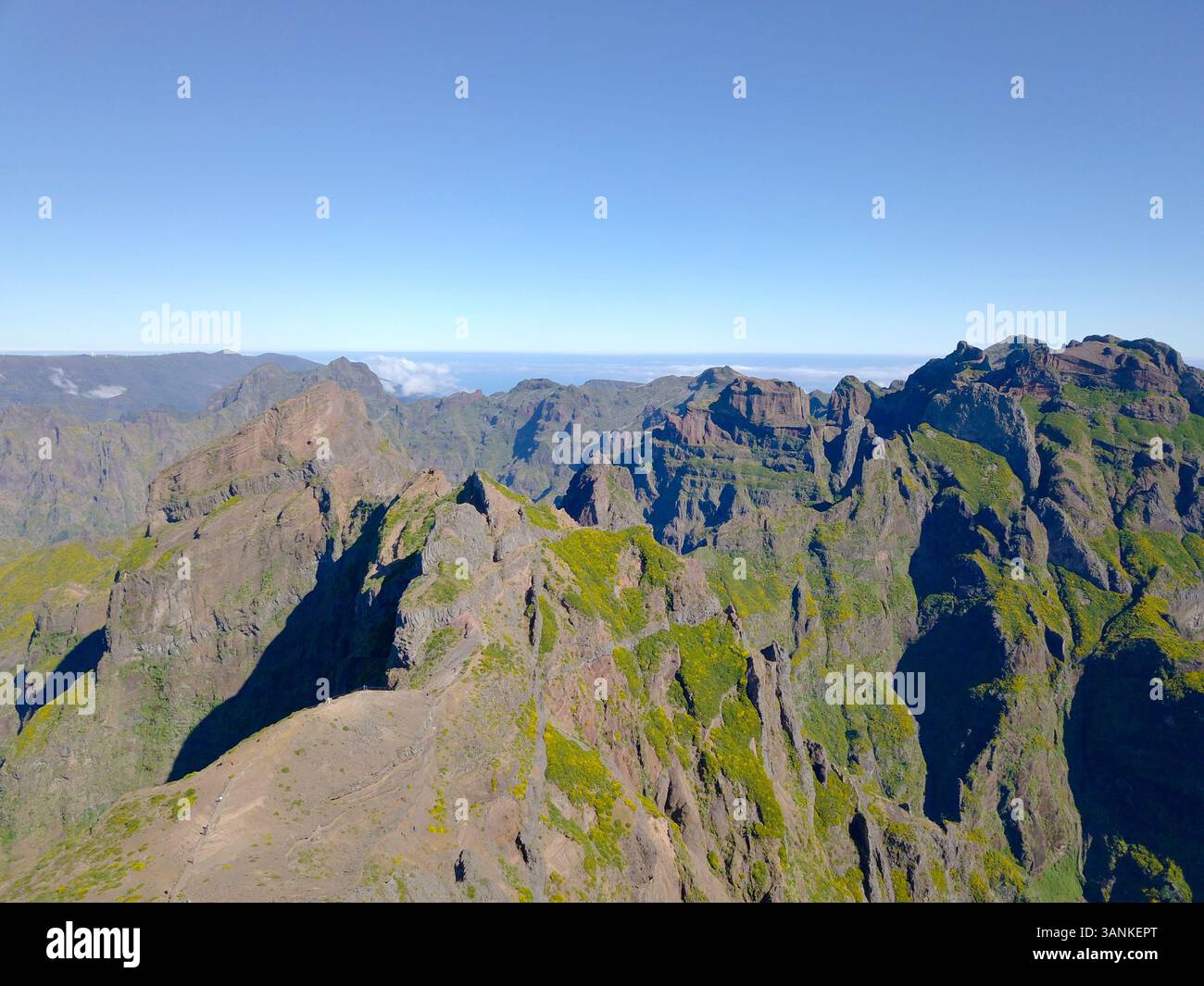 Aerial view of breathtaking rugged mountains under a sunny sky, Madeira ...