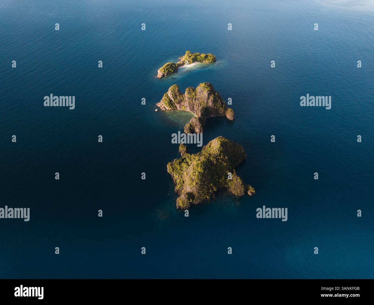 Aerial view of small islands with blue water in Misool, Raja Ampat ...