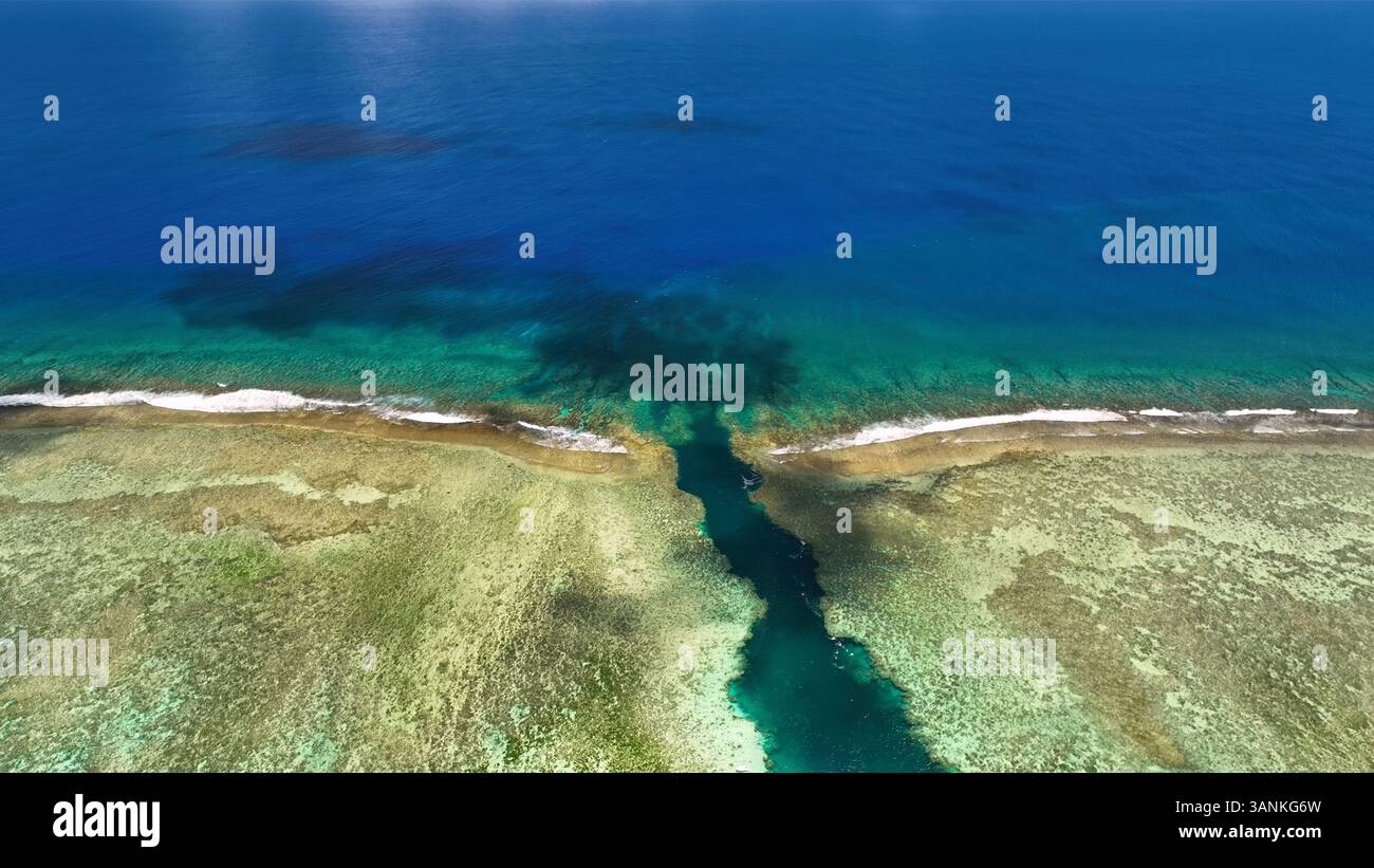 Aerial view of tropical reef and pristine ocean surrounding a beautiful ...