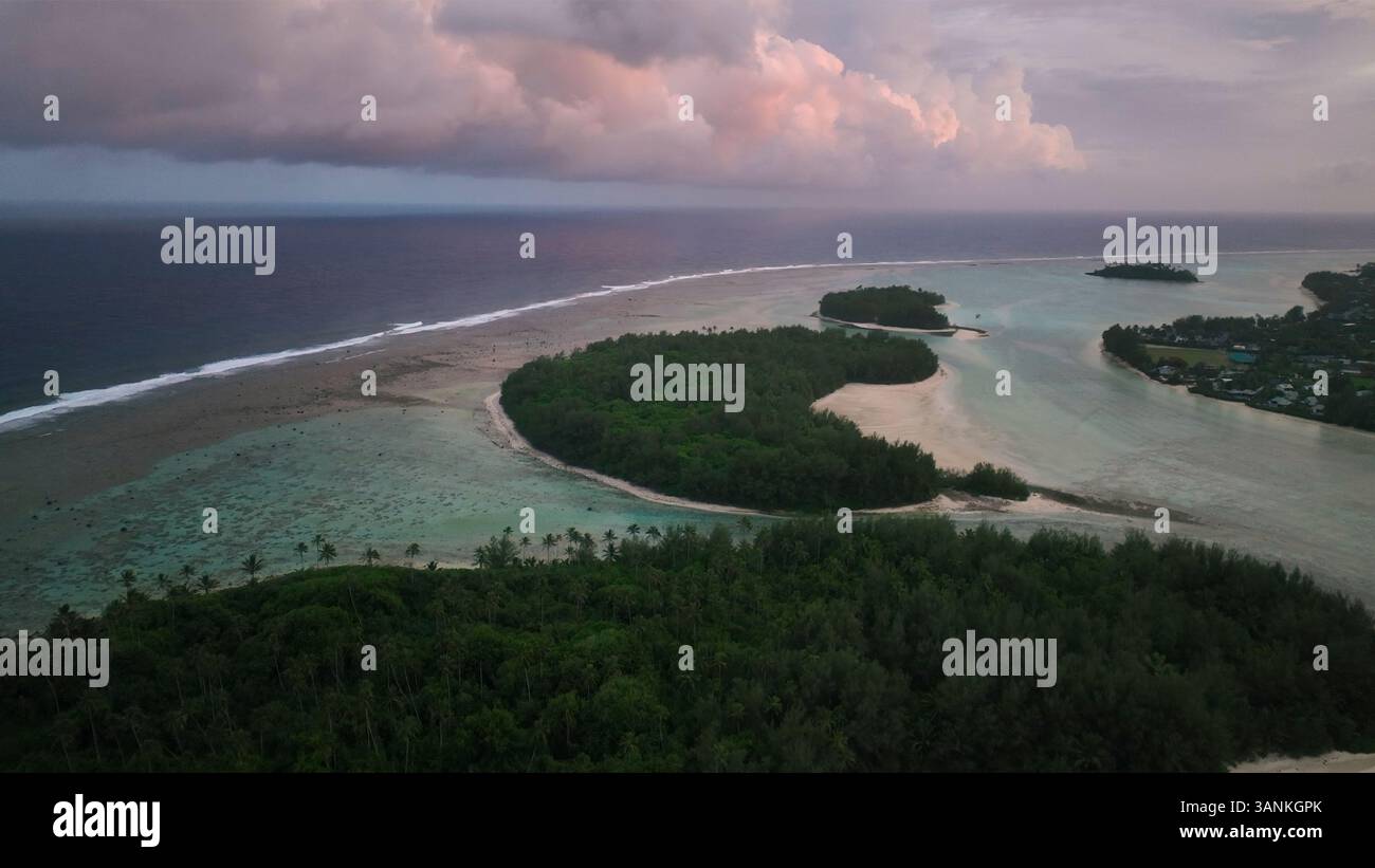 Aerial view of moody tropical islands with clouds and a vibrant reef ...