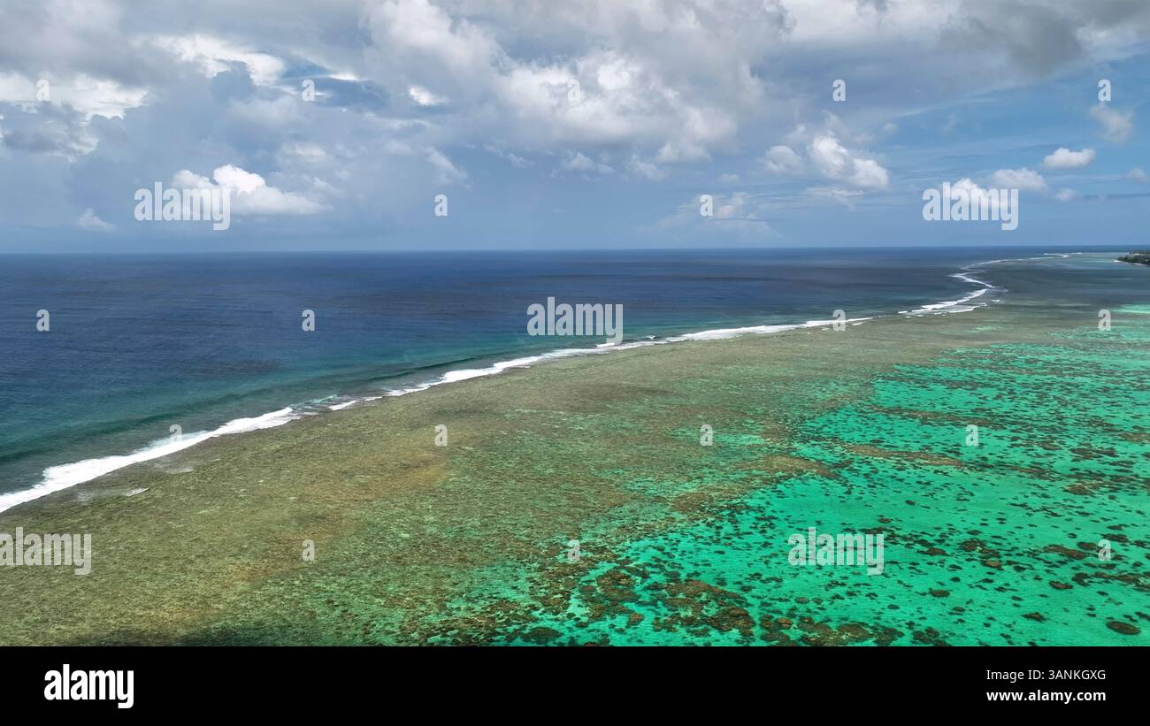 Aerial view of tropical reef and azure ocean surrounding a picturesque ...