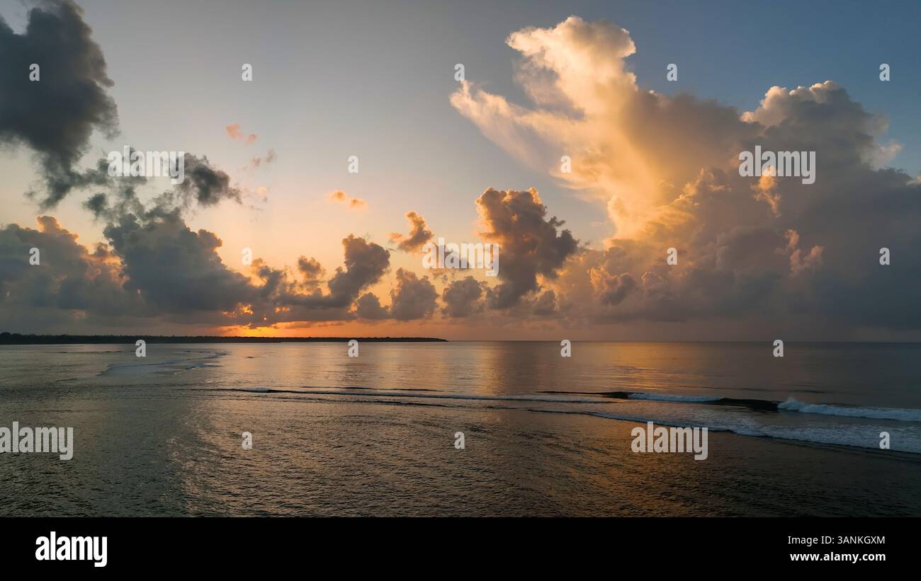 Aerial view of tropical sunset over the ocean with beautiful clouds ...
