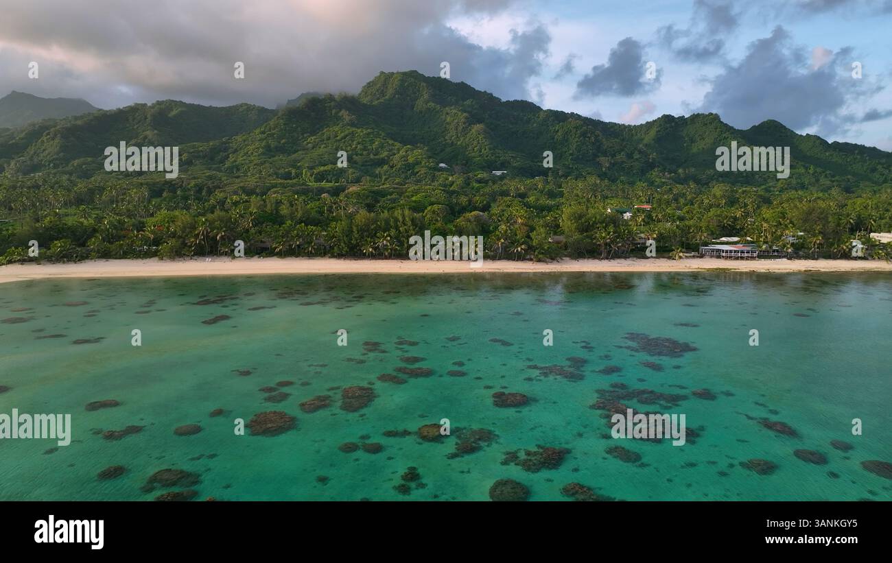 Aerial view of a tropical paradise with lush greenery, serene beach ...