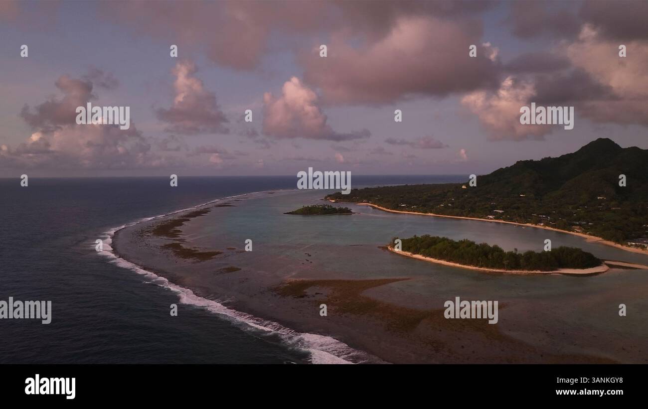 Aerial view of tropical islands and serene reef at sunrise, Avarua ...