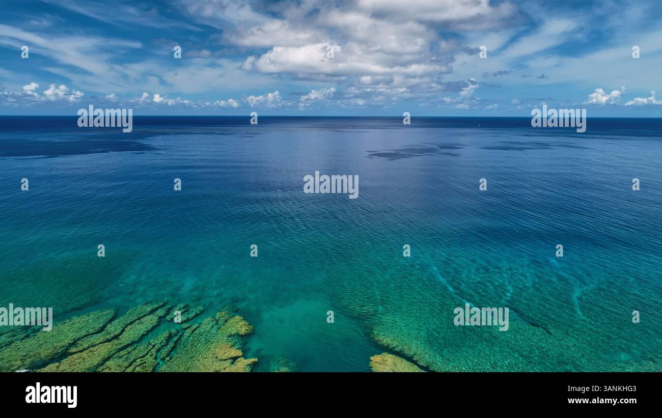 Aerial view of a breathtaking tropical reef and azure ocean under a ...