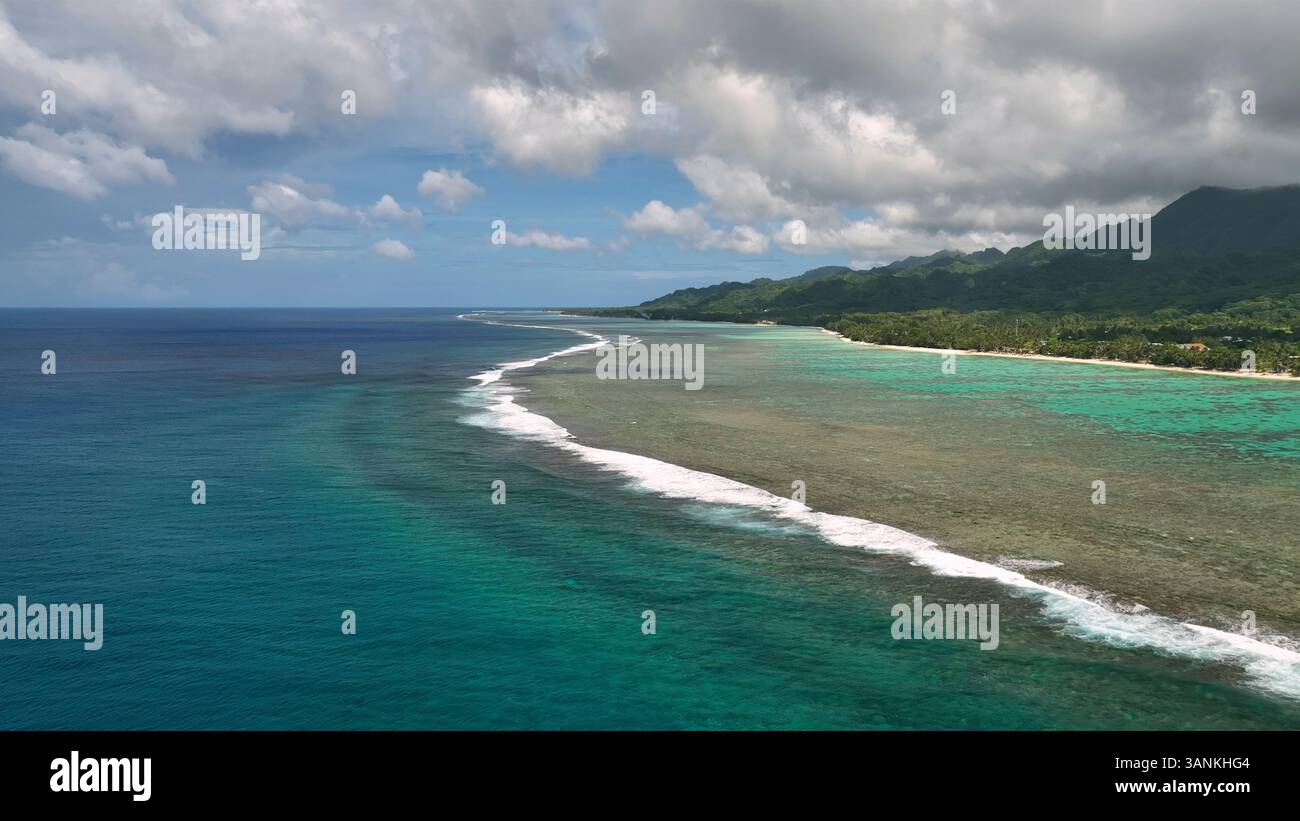 Aerial view of tropical reef and pristine blue ocean with lush ...
