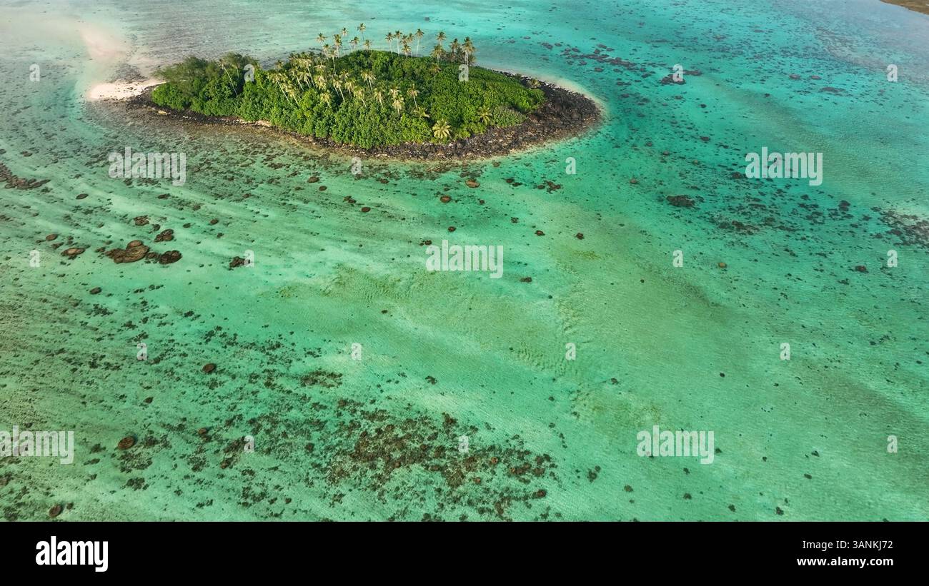 Aerial view of tropical island with pristine turquoise waters and lush ...
