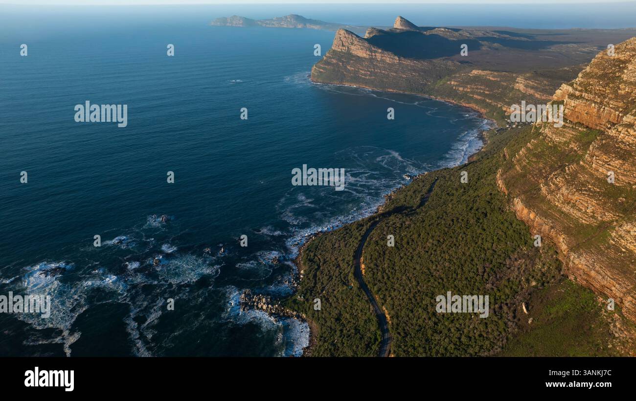 Aerial view of scenic coastline with crashing waves and rugged cliffs ...