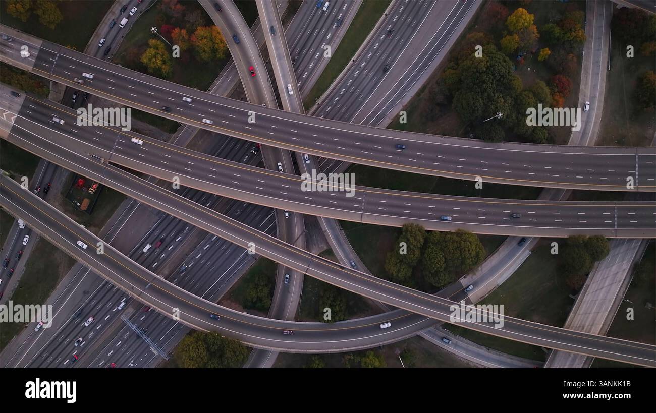 Aerial view of busy highway interchange with traffic and modern ...