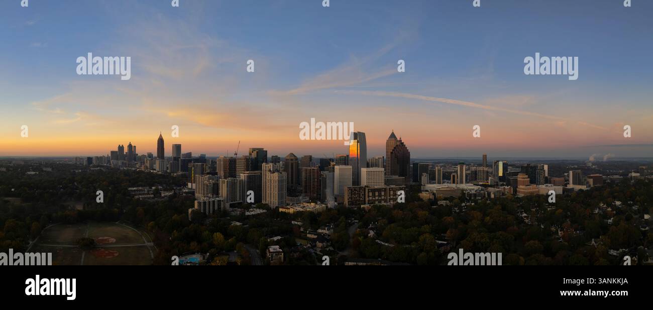 Aerial view of panoramic skyline with modern skyscrapers at sunset ...
