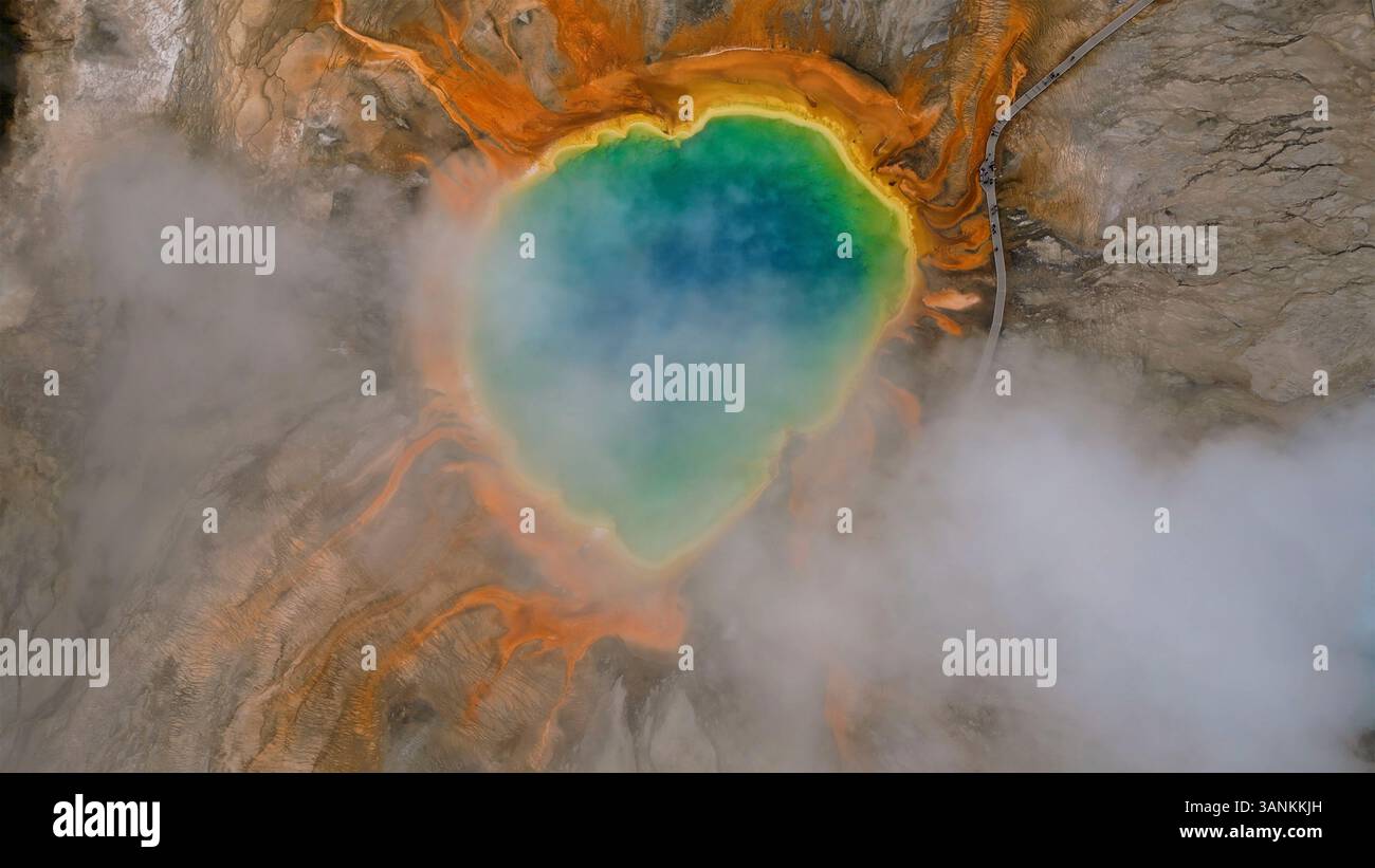Aerial view of grand prismatic spring with colorful patterns and mist ...