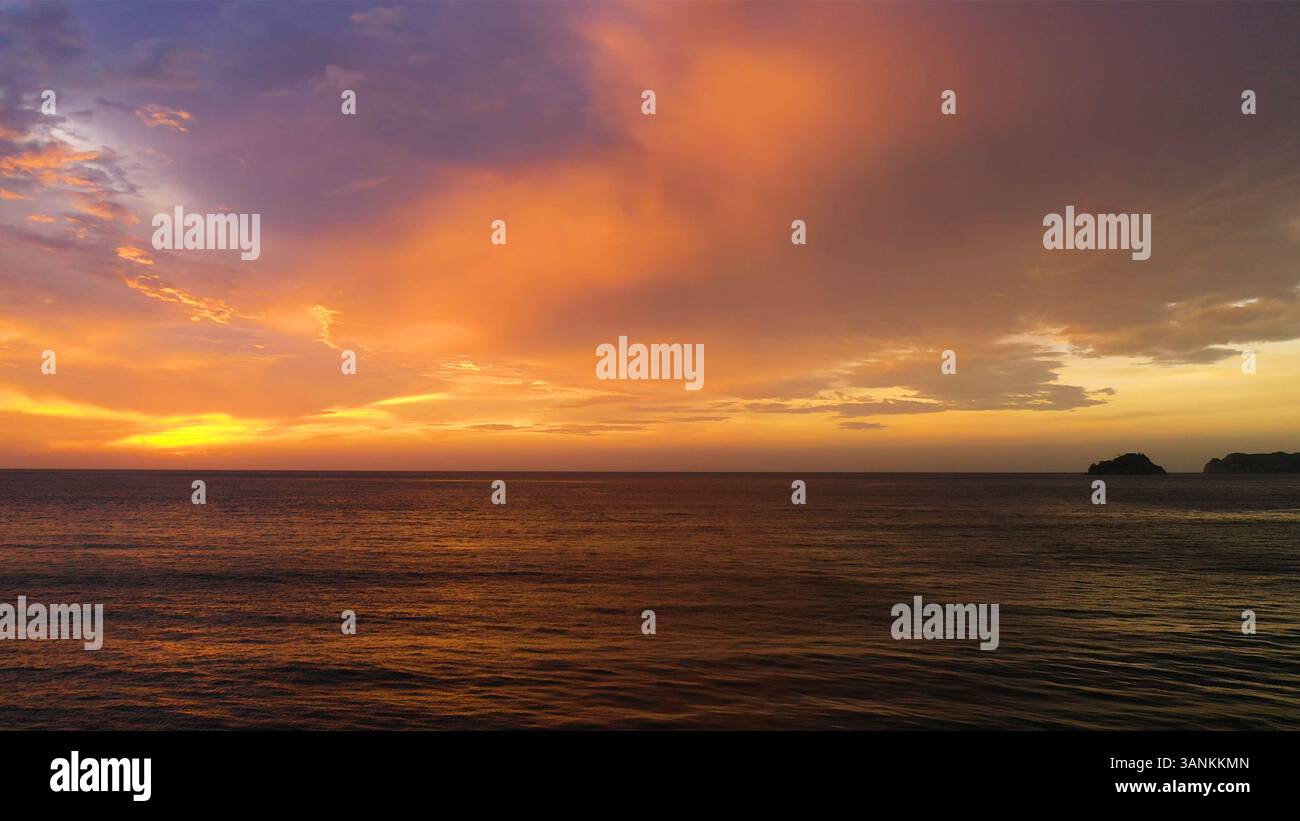 Aerial view of sunrise over tropical waves at a beautiful beach, Santa ...