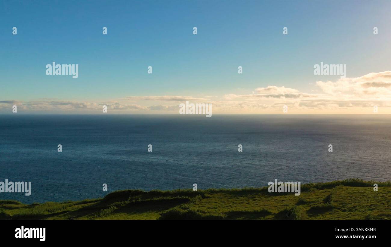Aerial view of beautiful serene coastline and azure ocean with lush ...