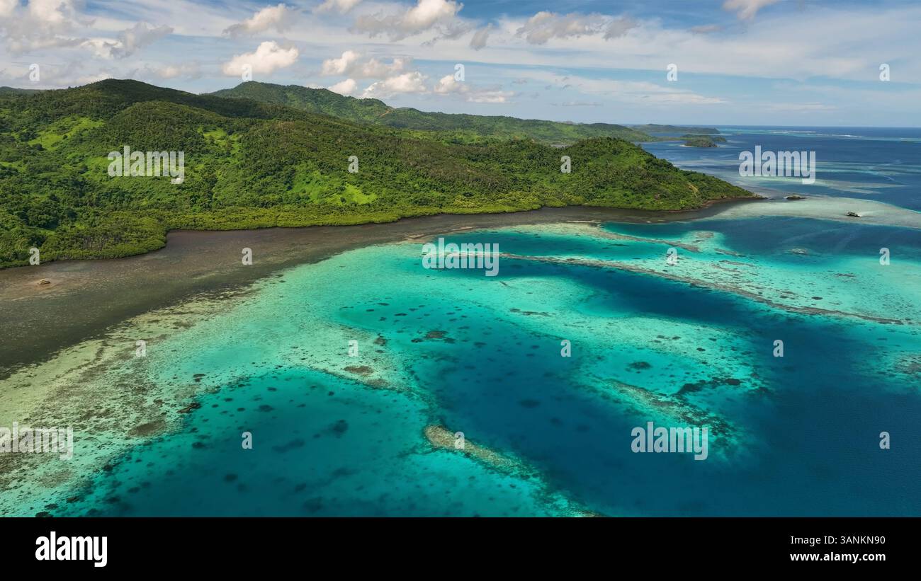 Aerial view of a beautiful tropical island with a reef and azure ocean ...