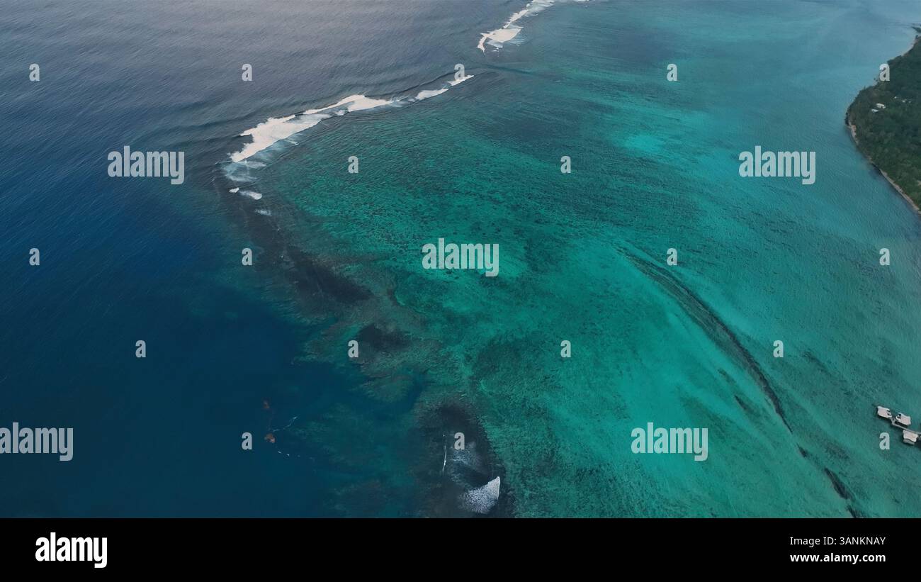 Aerial view of tropical island with beautiful turquoise reef and serene ...