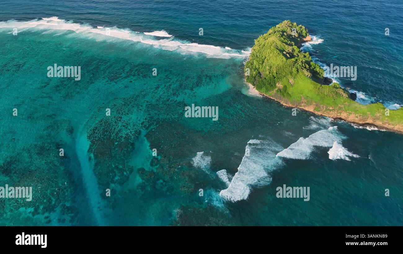 Aerial view of tropical island with lush vegetation and clear water ...