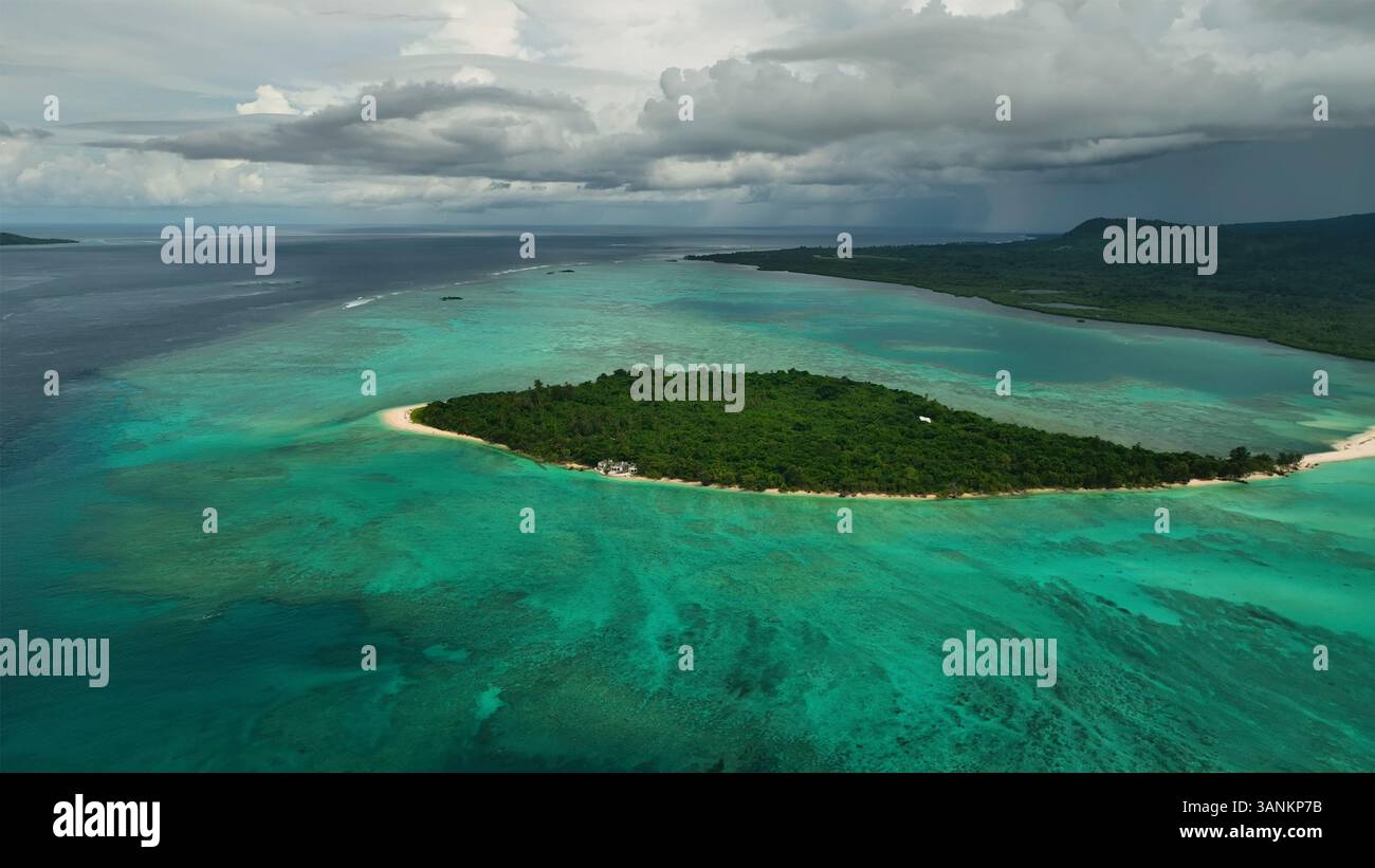 Aerial view of a pristine tropical island with azure lagoon and lush ...