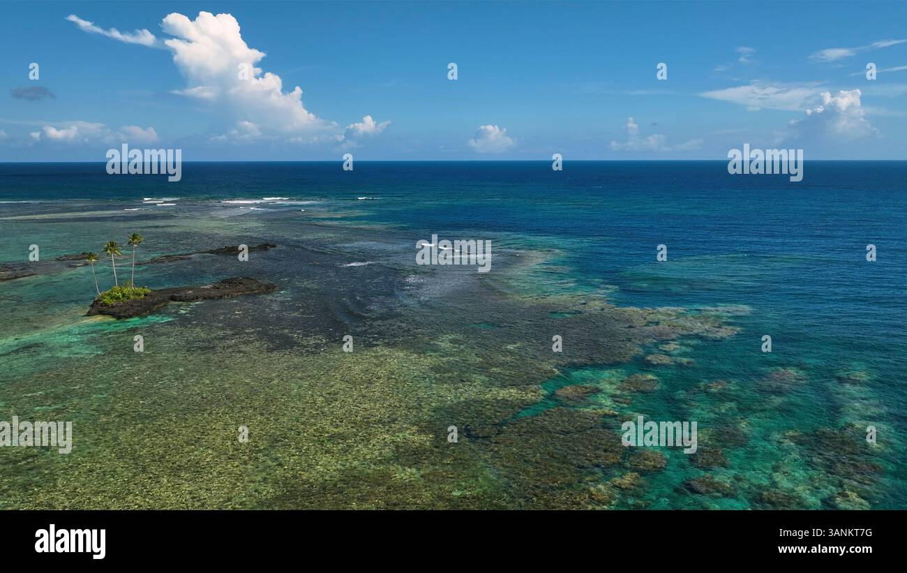 Aerial view of a tropical island with pristine blue water and coral ...