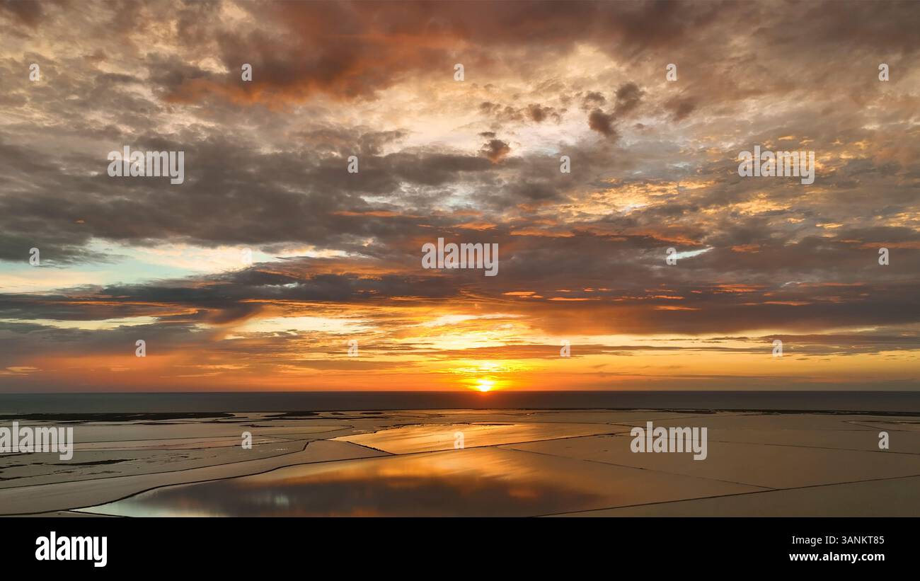 Aerial view of serene tropical reef at sunrise with beautiful clouds ...