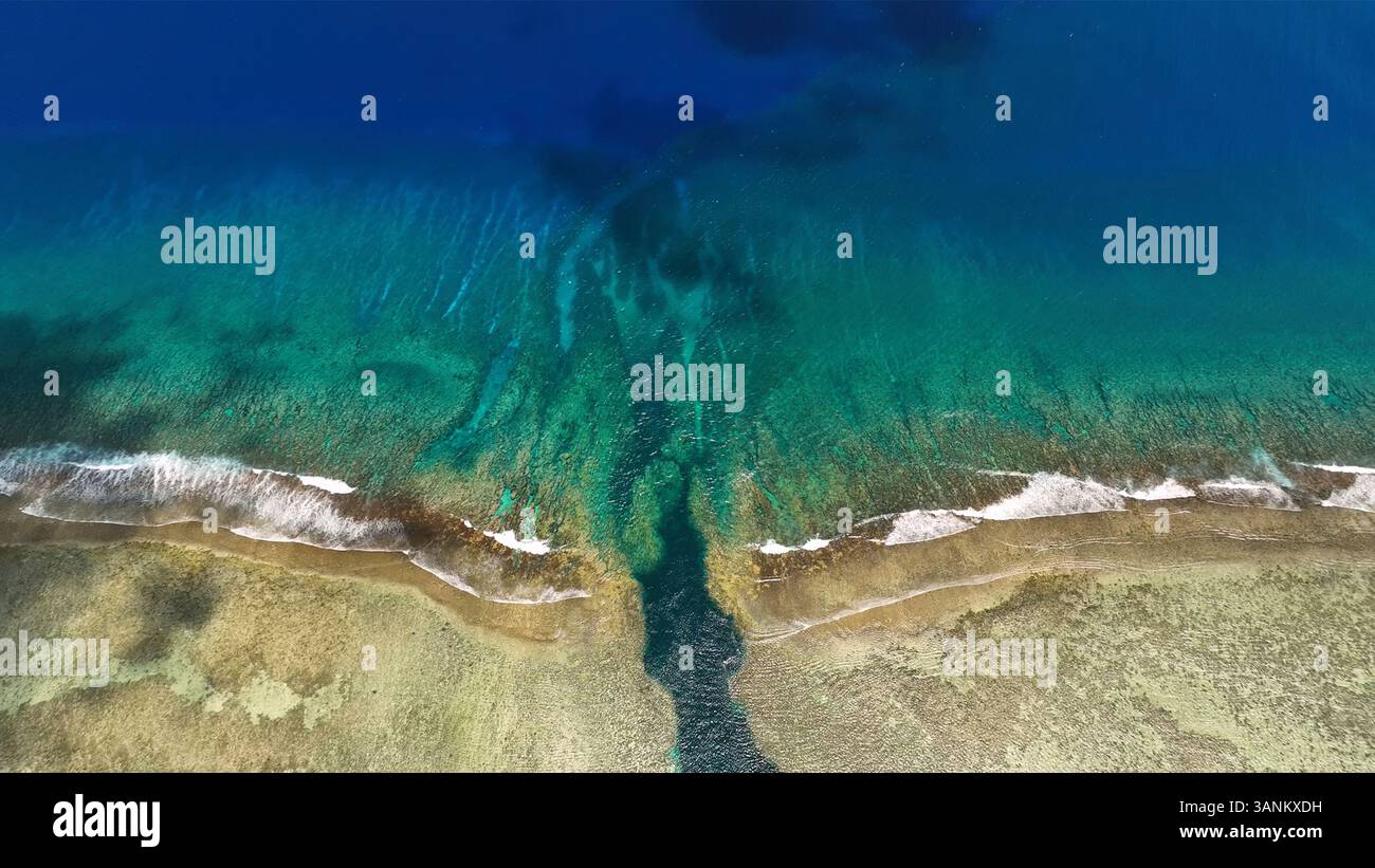Aerial view of vibrant turquoise lagoon with pristine coral reef and ...