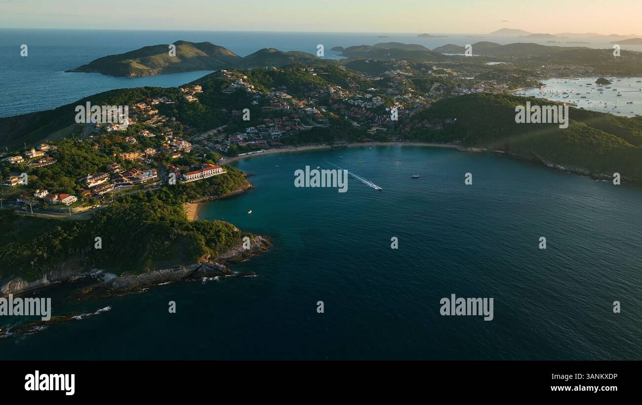 Aerial view of a beautiful coastal bay with homes and lush hills ...