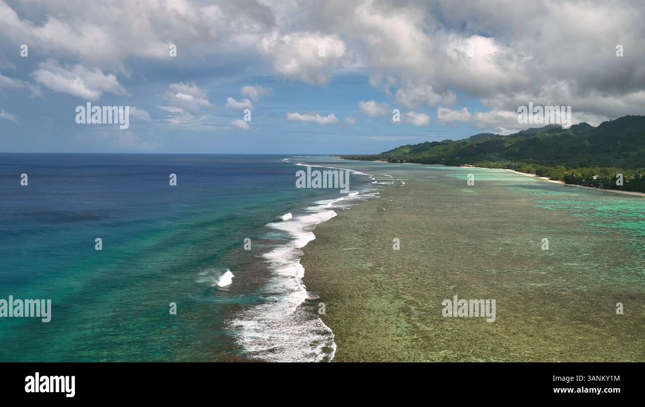 Aerial view of serene tropical beach with clear blue water and coral ...