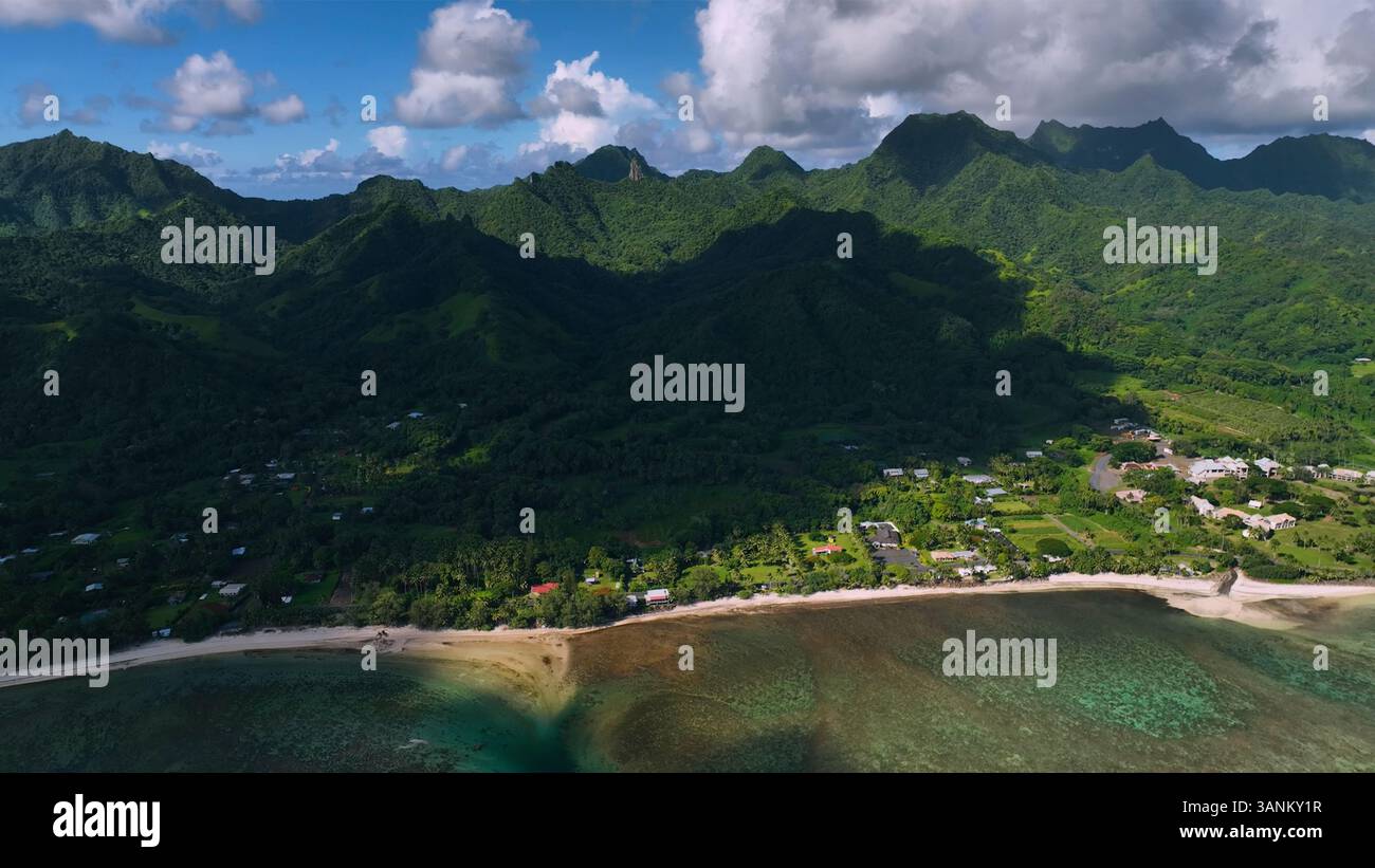 Aerial view of beautiful tropical beach with scenic mountains and blue ...