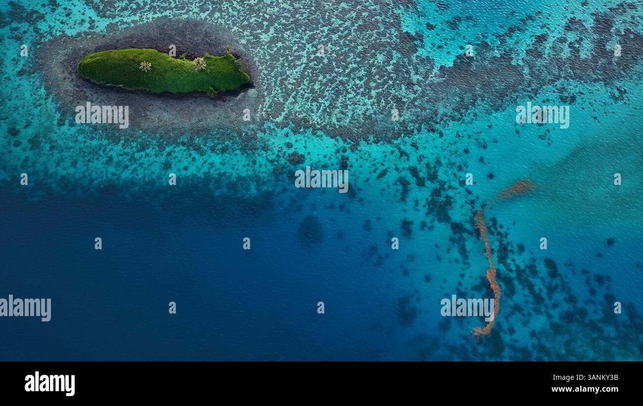 Aerial view of tranquil island with azure reef and clear water, Eastern ...