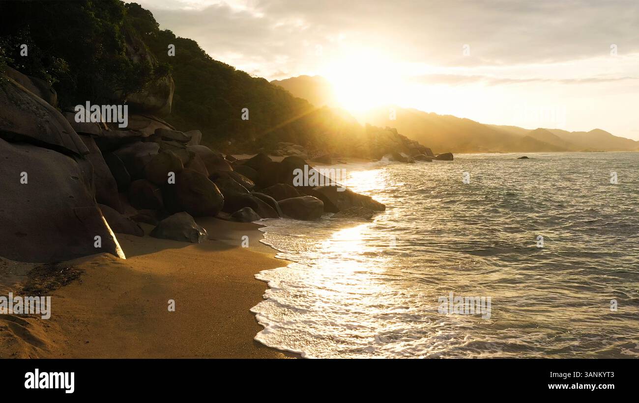 Aerial view of sunset over coastal jungle and beach in Santa Marta ...