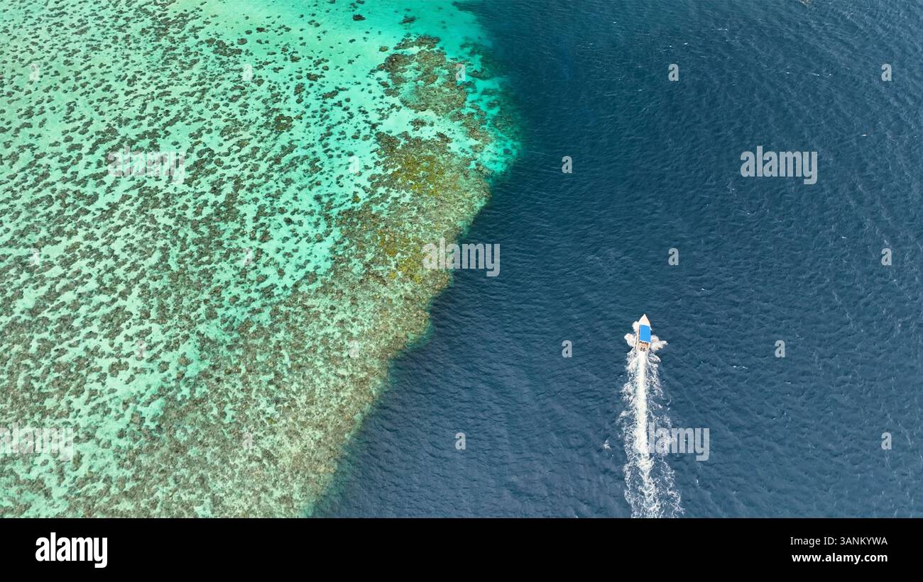 Aerial view of crystal clear ocean with reef and boat, Fiji Stock Photo ...