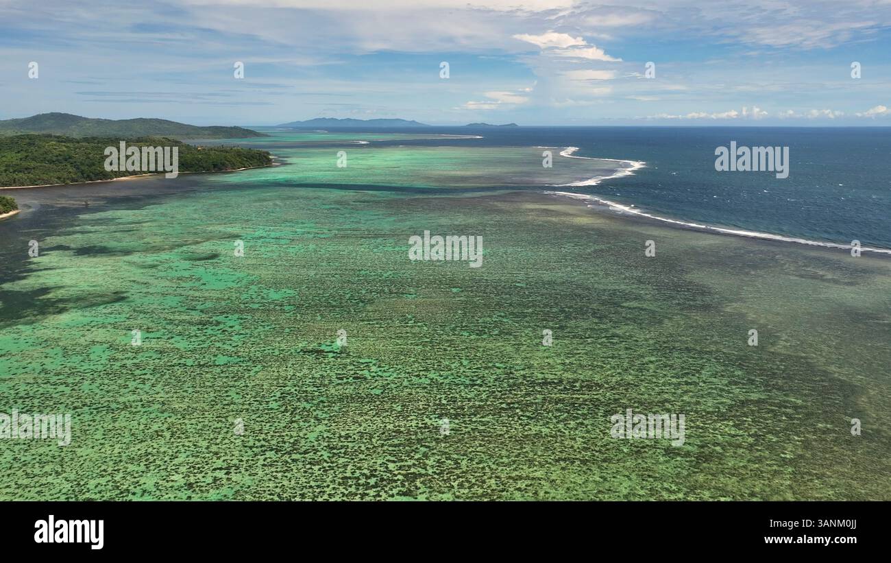 Aerial view of tropical island with clear turquoise water and coral ...