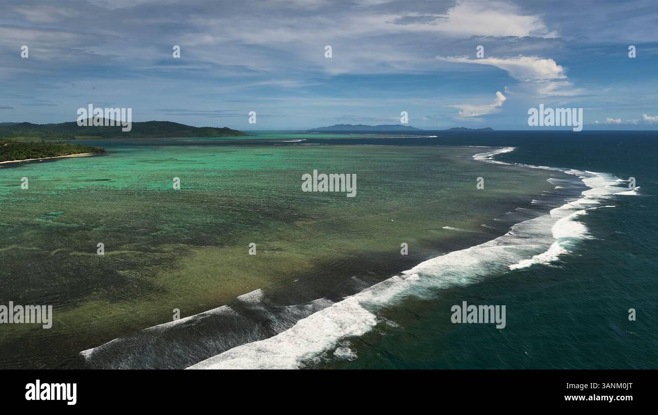 Aerial view of tropical island with reef and ocean waves, Central, Fiji ...